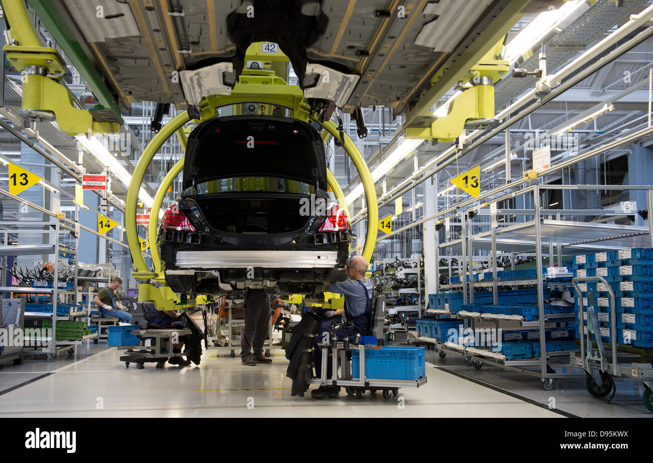 An employee of Daimler Ag assembles a Mercedes-Benz S-Class at the ...