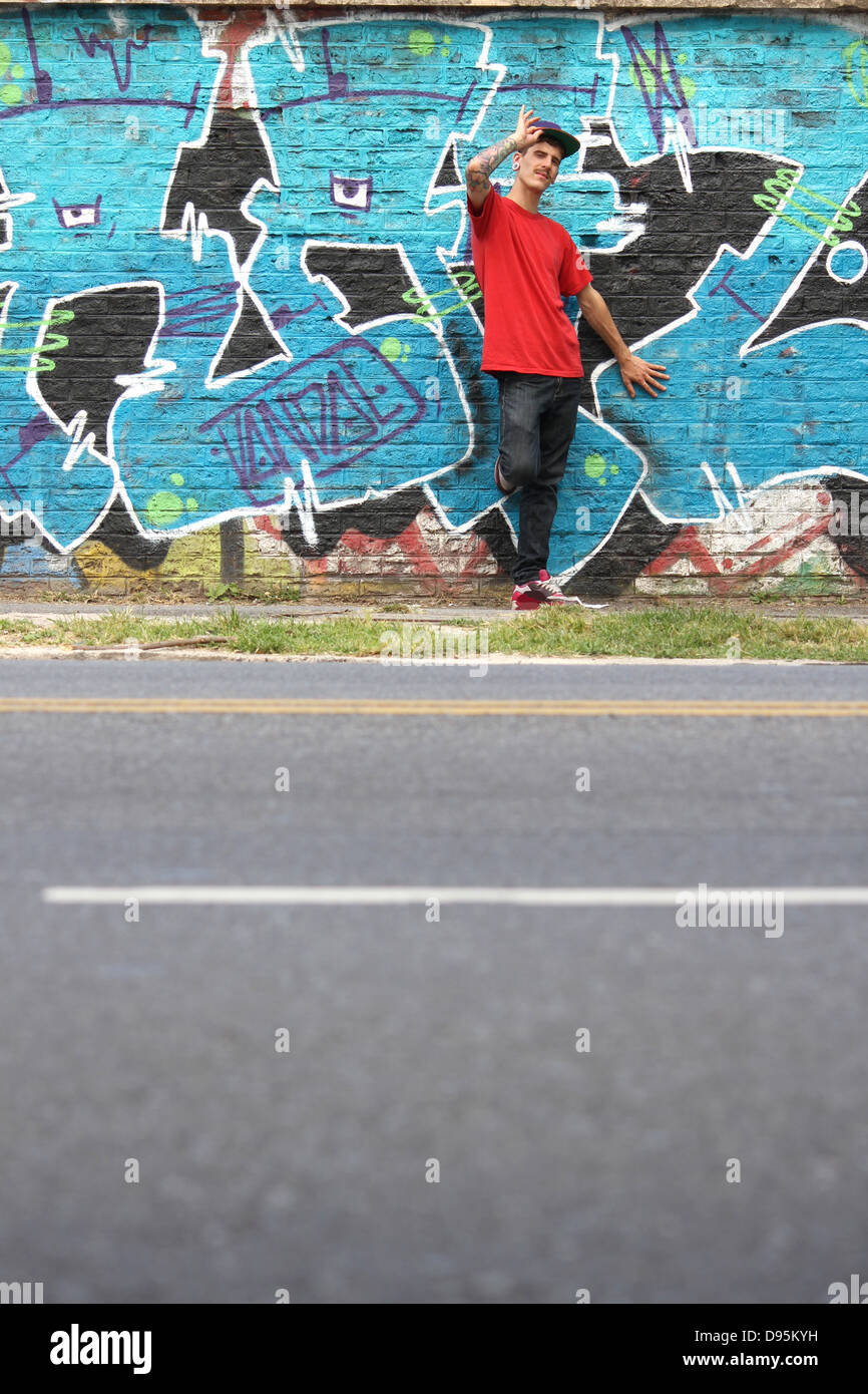 A greeting young Rapper greeting in front of a Graffiti wall Stock ...