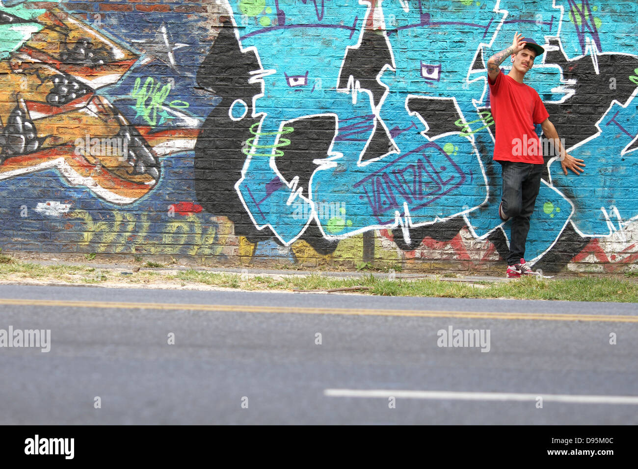 A greeting young Rapper greeting in front of a Graffiti wall Stock ...