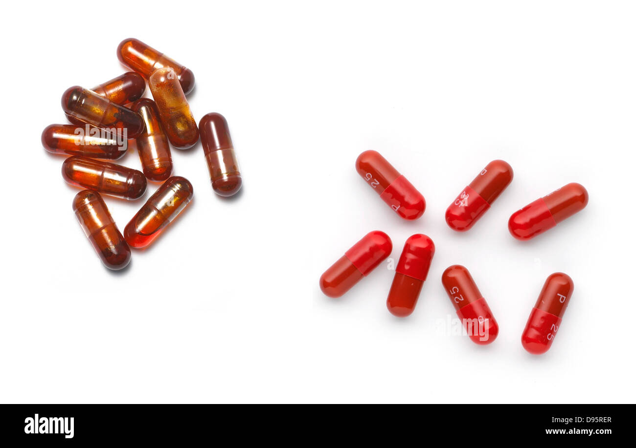 red capsules cut out onto a white background Stock Photo - Alamy