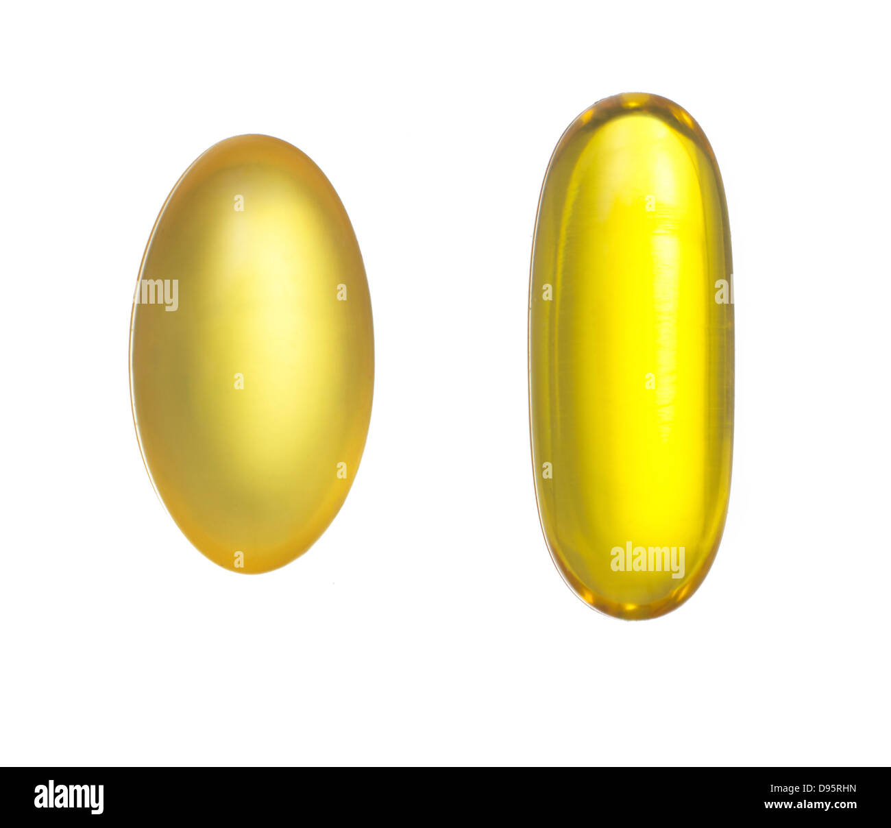 yellow capsules cut out onto a white background Stock Photo - Alamy