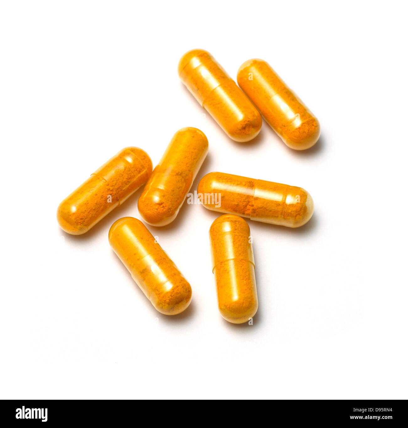 yellow capsules cut out onto a white background Stock Photo - Alamy
