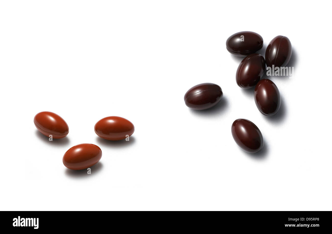 red pills cut out onto a white background Stock Photo - Alamy