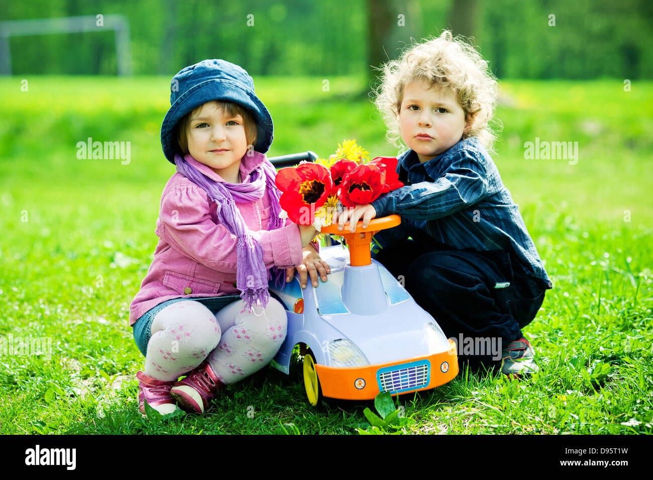 boy and girl in park with toy car Stock Photo - Alamy