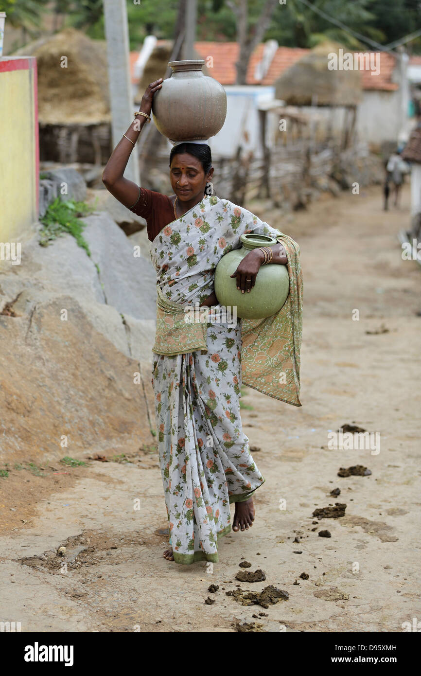 Woman carrying water jar hi-res stock photography and images - Alamy