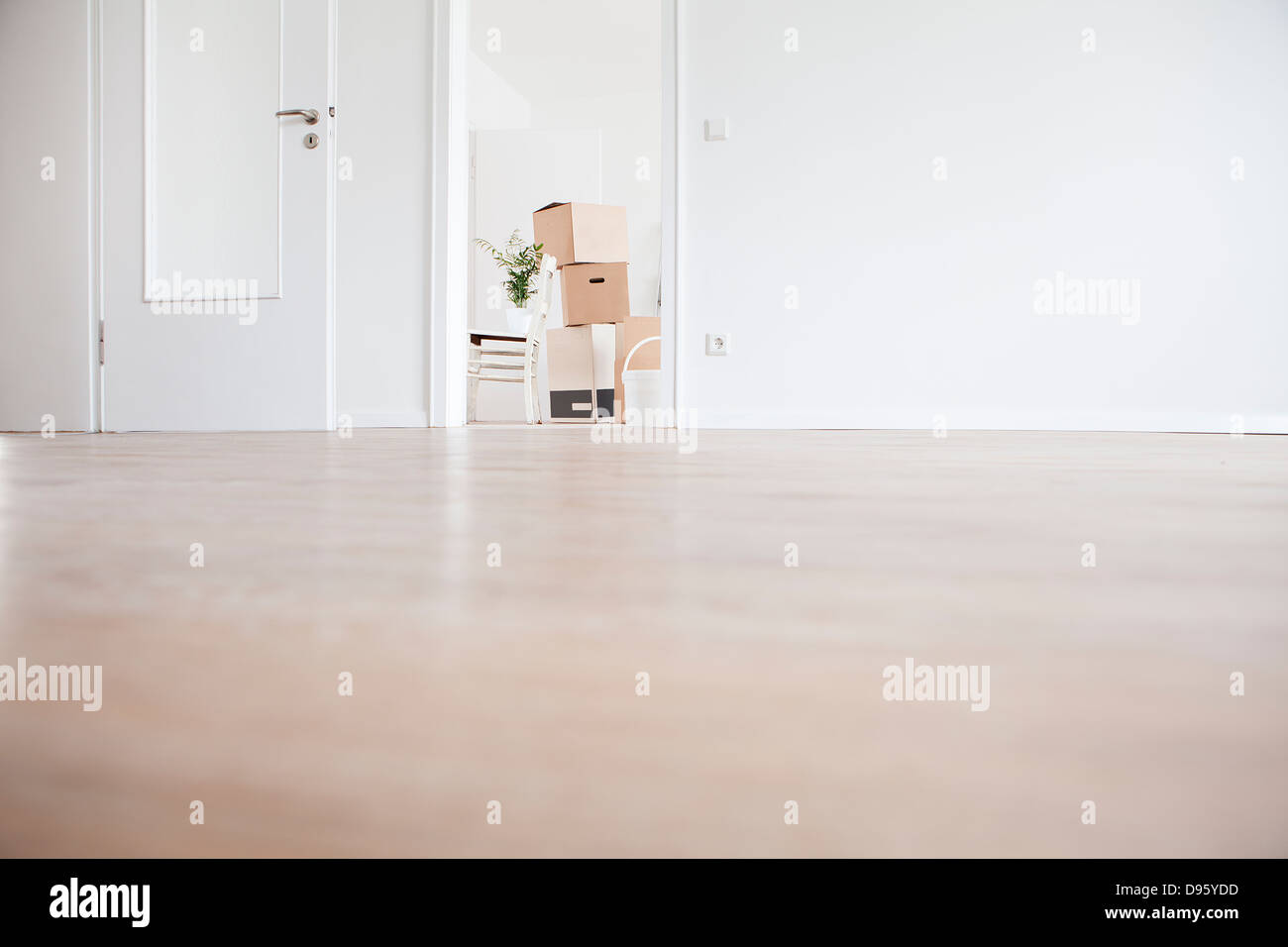 Moving house with box and chair in background Stock Photo - Alamy