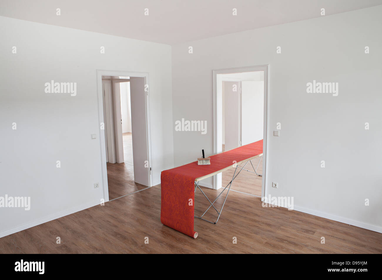 Wallpaper on table while wallpaper brush on it Stock Photo - Alamy
