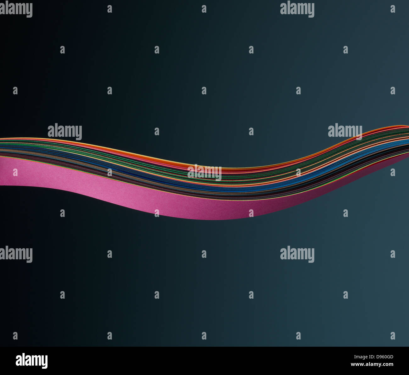 cut colored paper strips twisted and curved on a gray background Stock ...