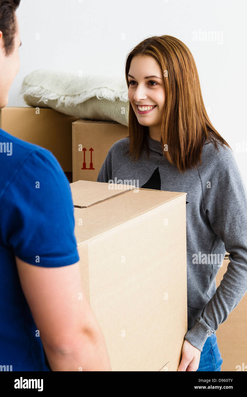 Germany Munich Young Couple Holding Cardboard Box Smiling Stock