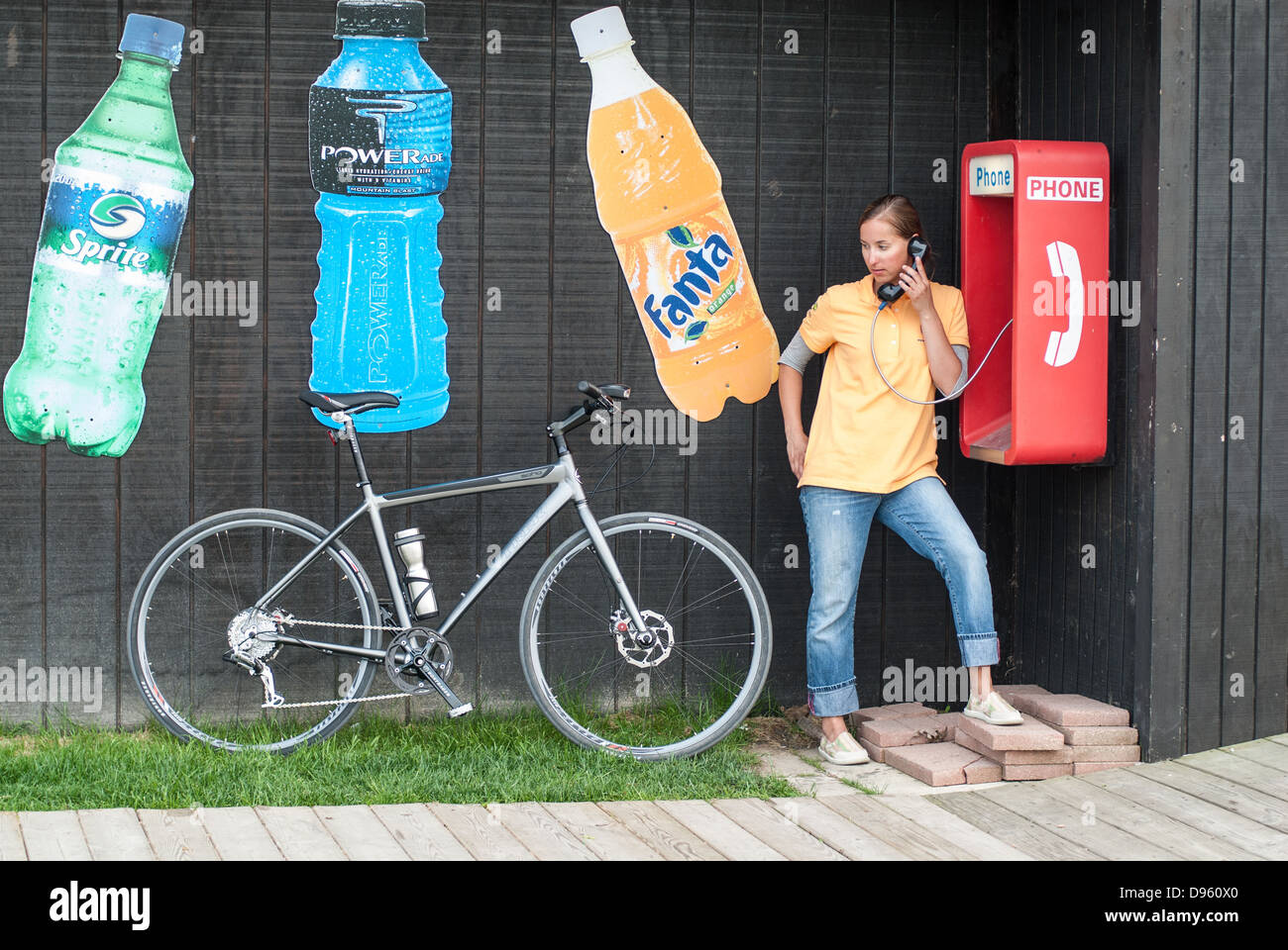woman speaking on payphone outside general store Stock Photo - Alamy