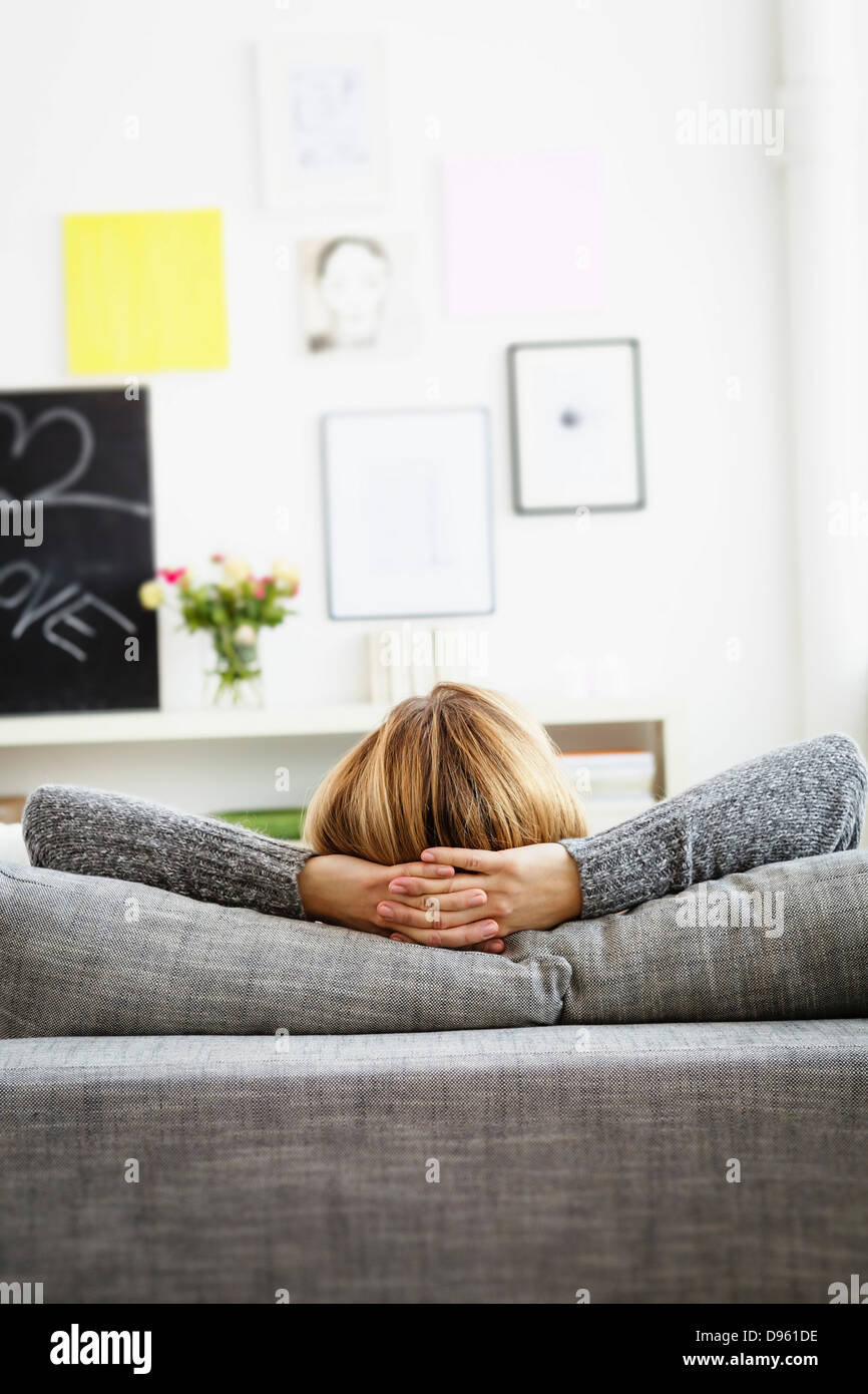 Germany, Bavaria, Munich, Young woman relaxing on couch Stock Photo - Alamy
