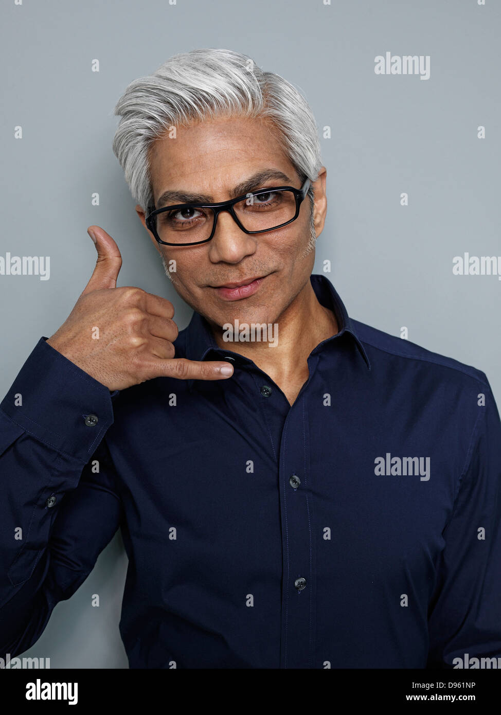 Businessman gesturing call, portrait Stock Photo - Alamy