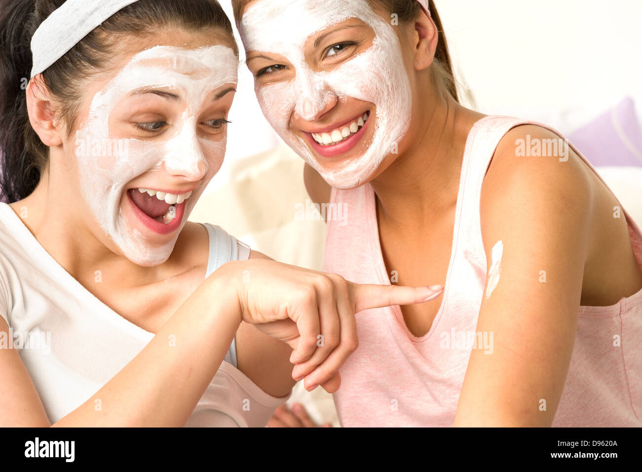 Laughing caucasian girls wearing peeling mask having fun Stock Photo ...