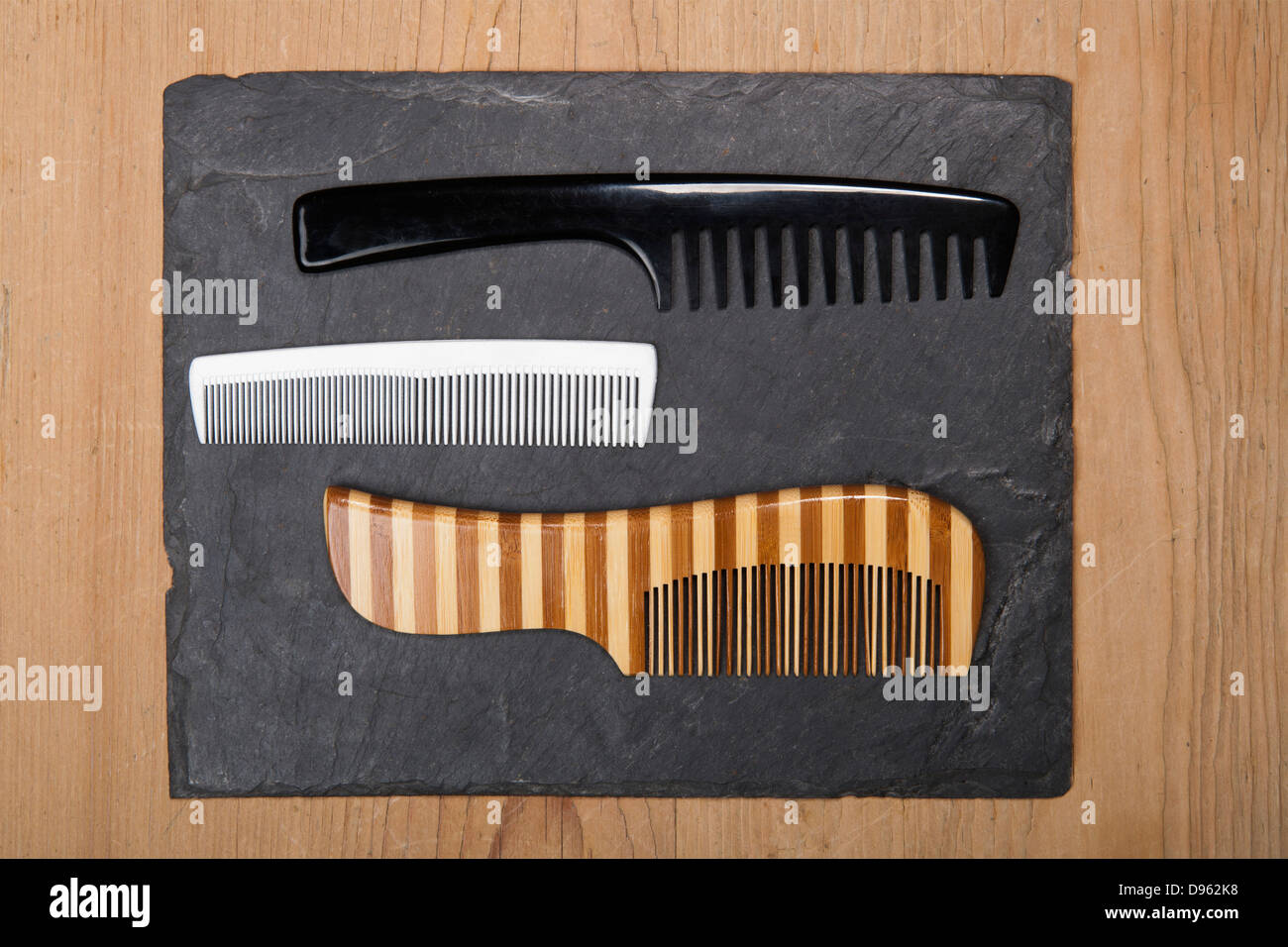 Various hair combs on slate board, close up Stock Photo - Alamy
