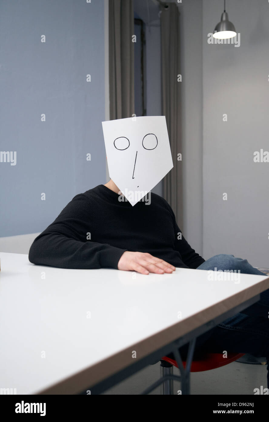 Man covering face with mask Stock Photo - Alamy