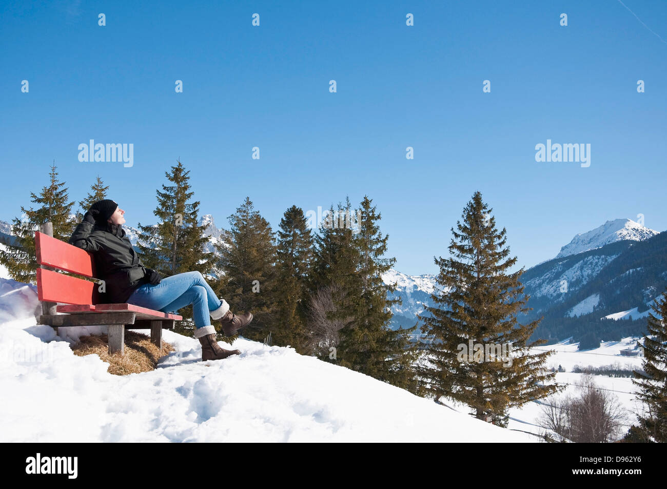 Woman relaxing on bench at tannheim alps hi-res stock photography and ...
