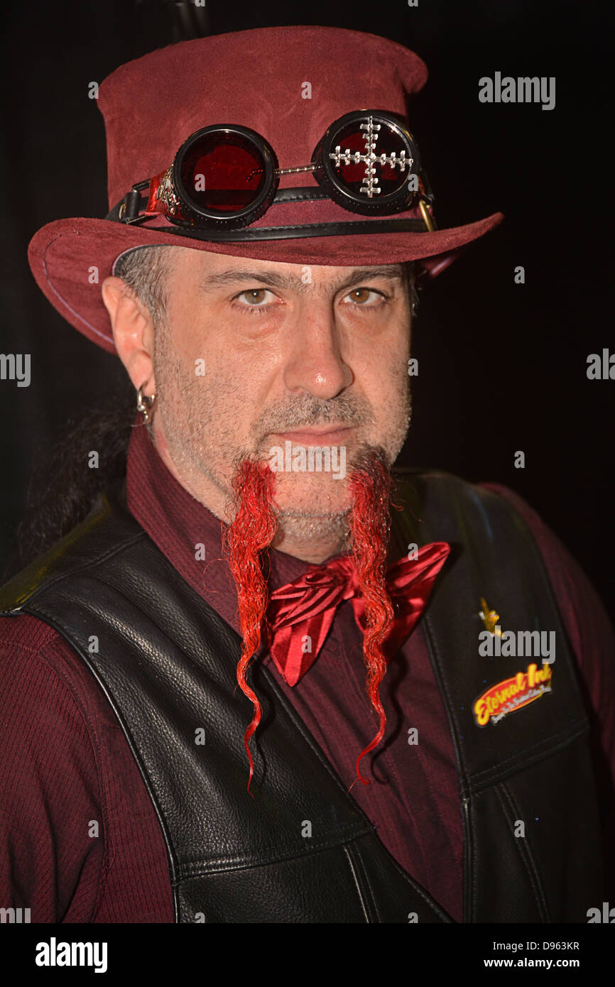 Portrait of Syx in a red derby with and odd red moustache at the New ...