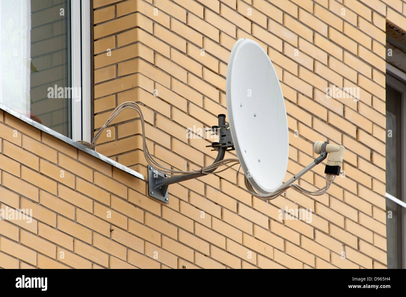 Antenna on wall near the window. Brick wall Stock Photo - Alamy