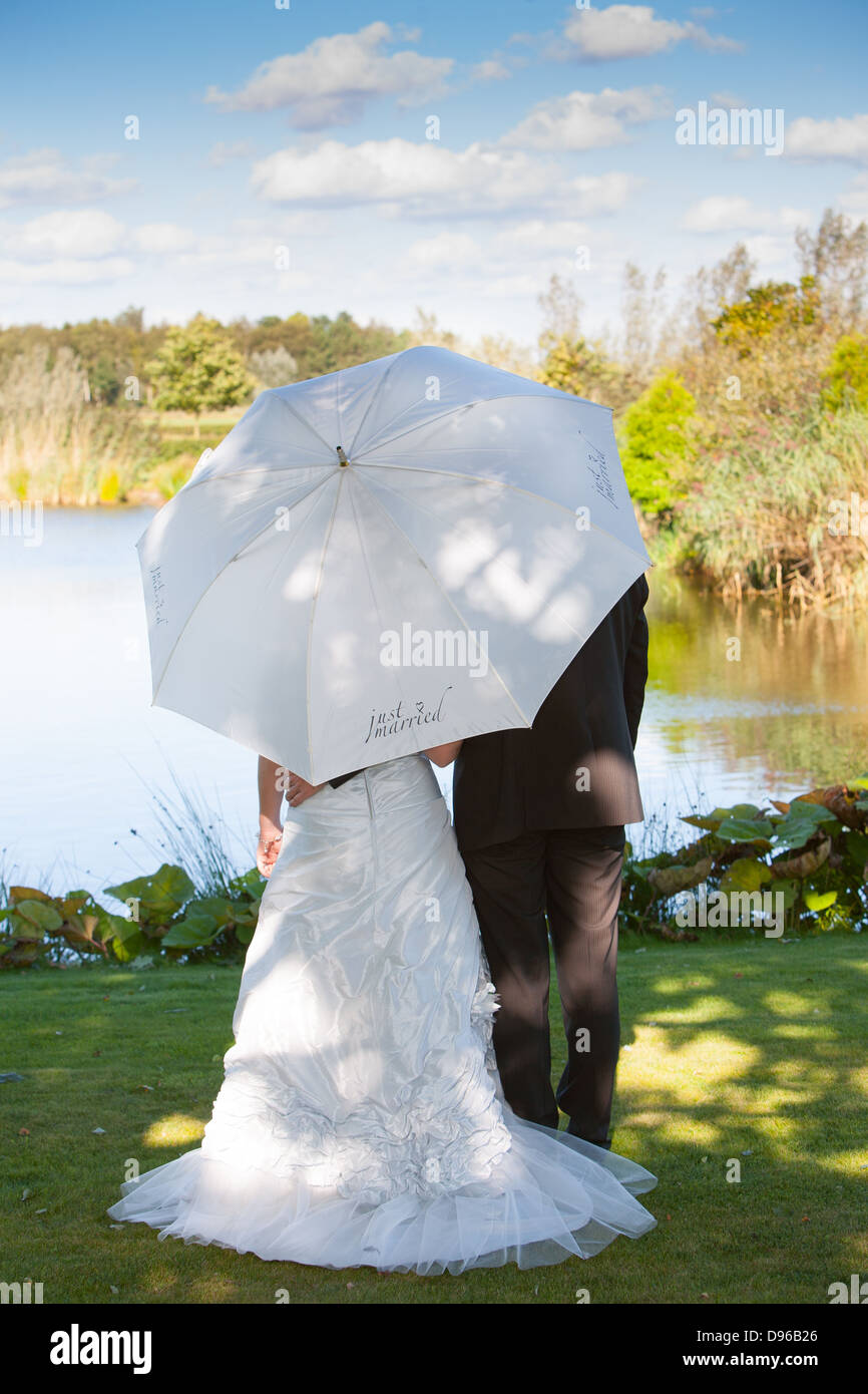Newly wed couple in an outside setting for their wedding photography ...