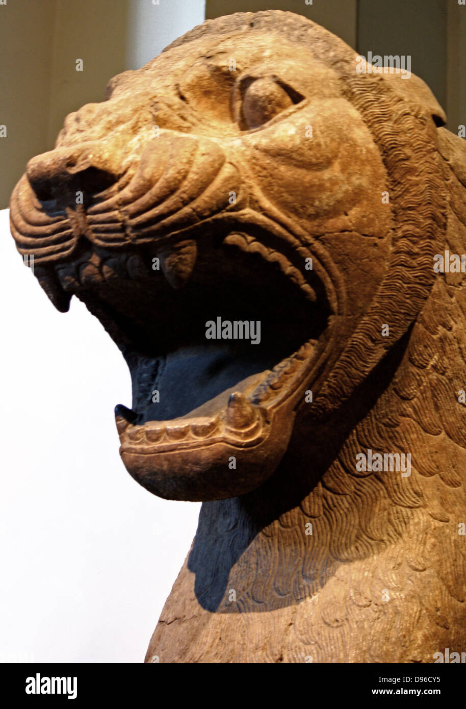 statue of a lion set as a guardian figure at the entrance to the Temple ...