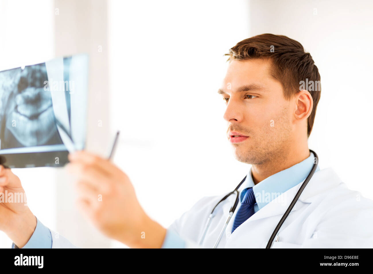 male doctor or dentist looking at x-ray Stock Photo - Alamy