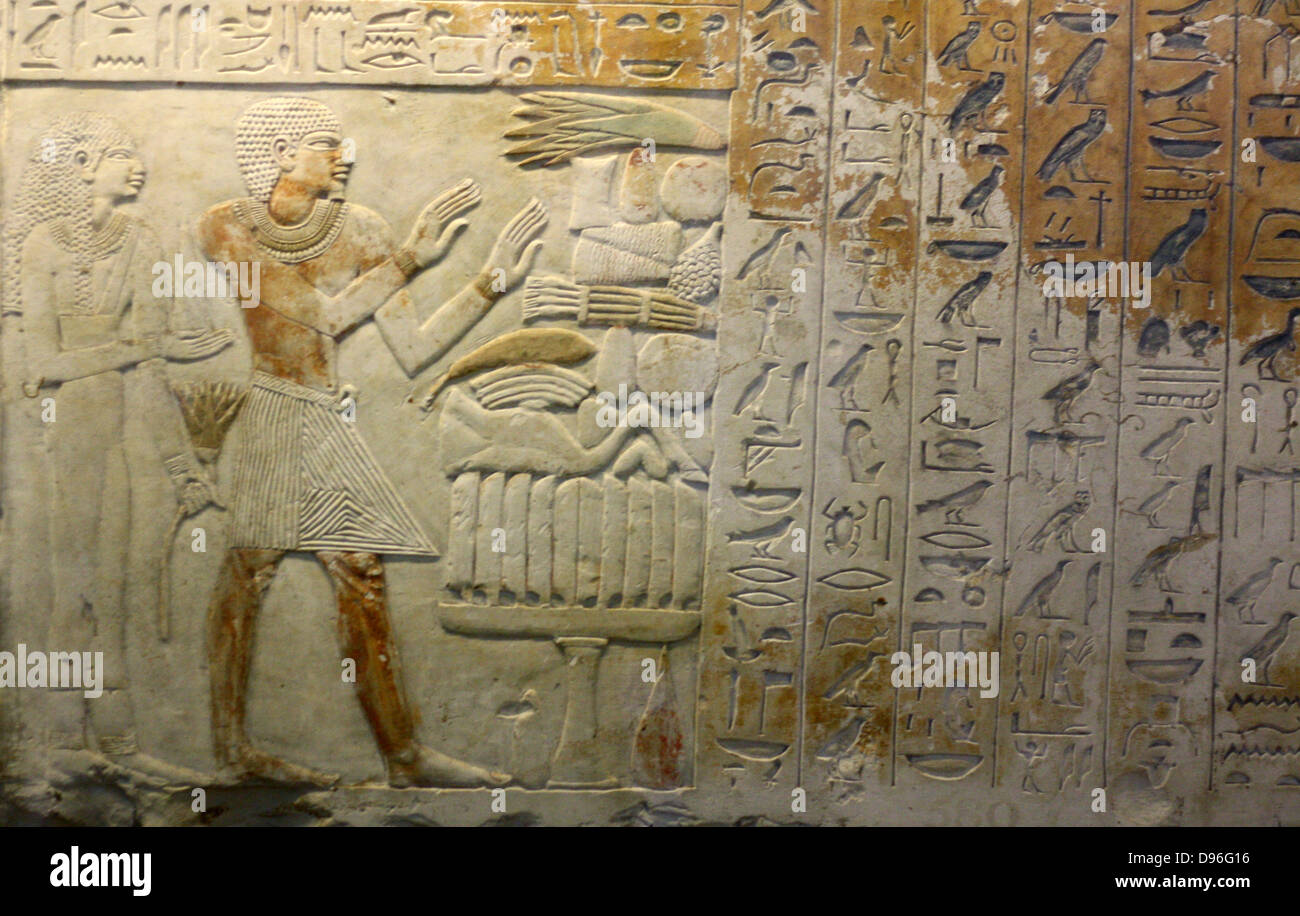 Egyptian wall relief. Depicting figures giving food and offerings. Also ...