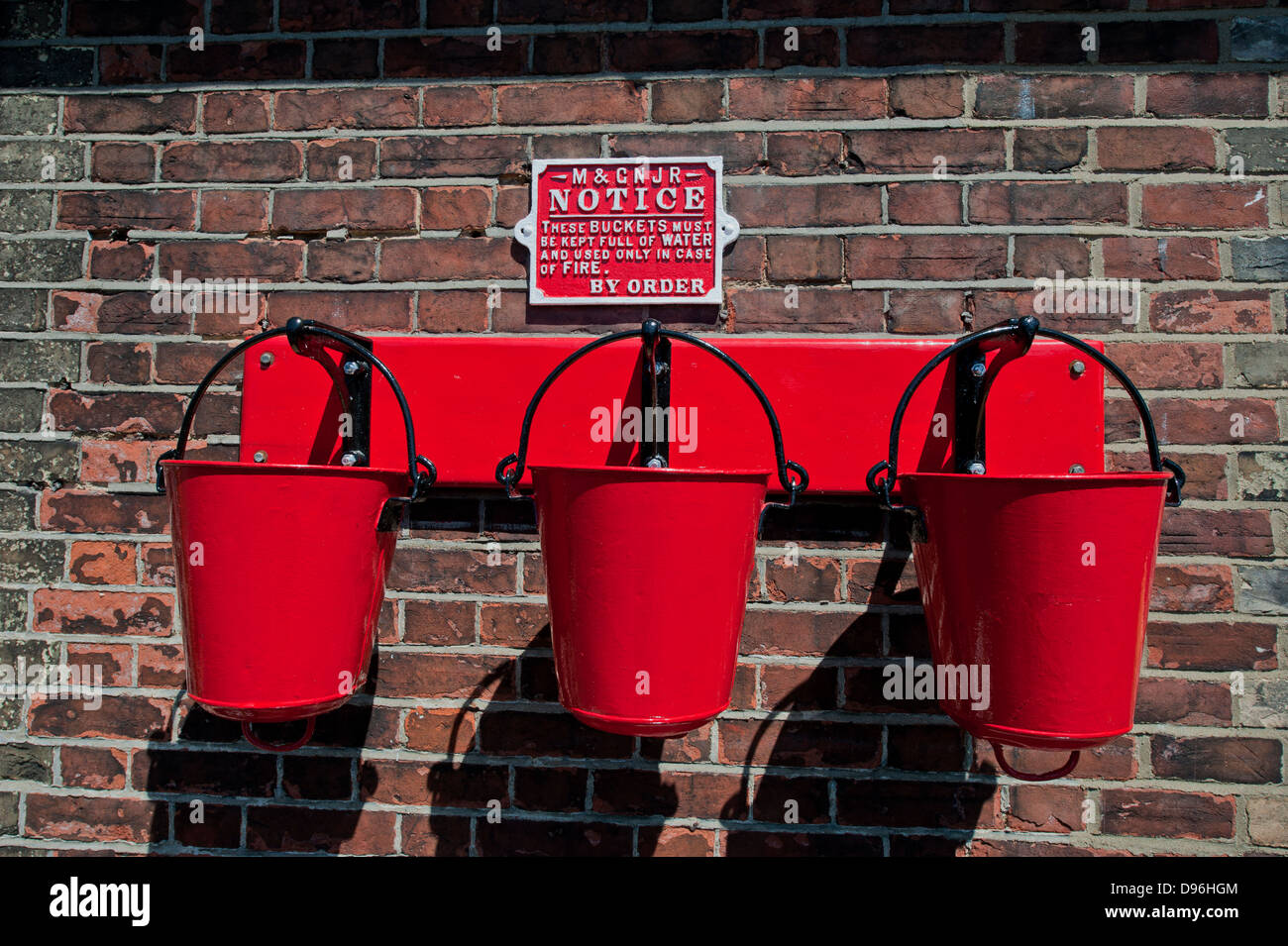Vintage steam rail transport fire buckets hanging on wall Stock Photo ...