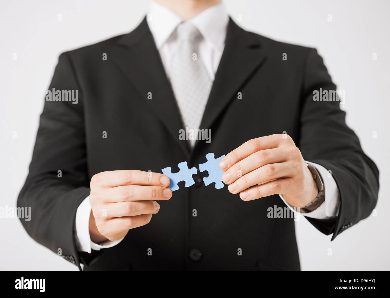 man trying to connect puzzle pieces Stock Photo - Alamy