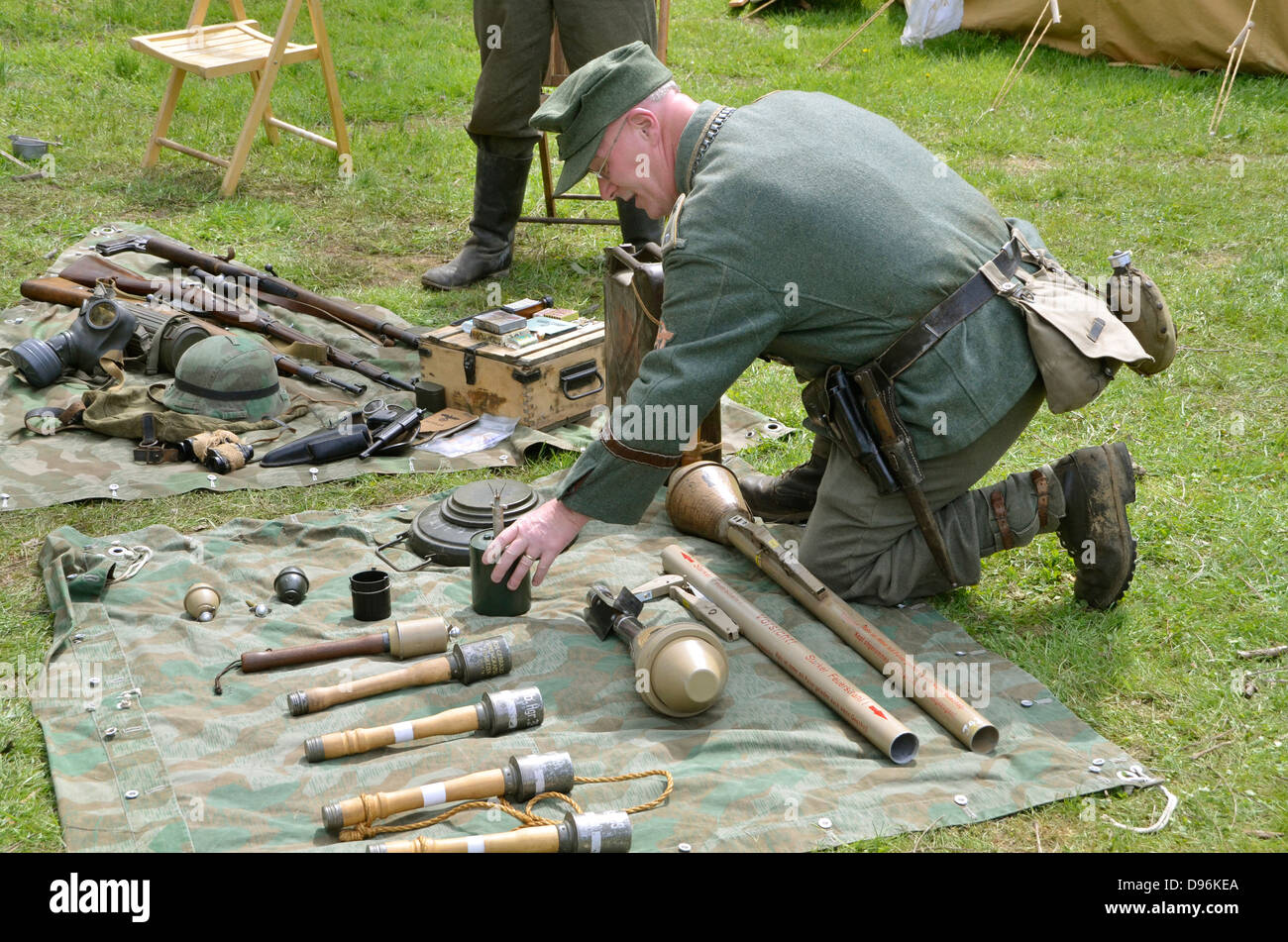 A man portraying a Nazi soldiers shows a variety of landmines Germans ...