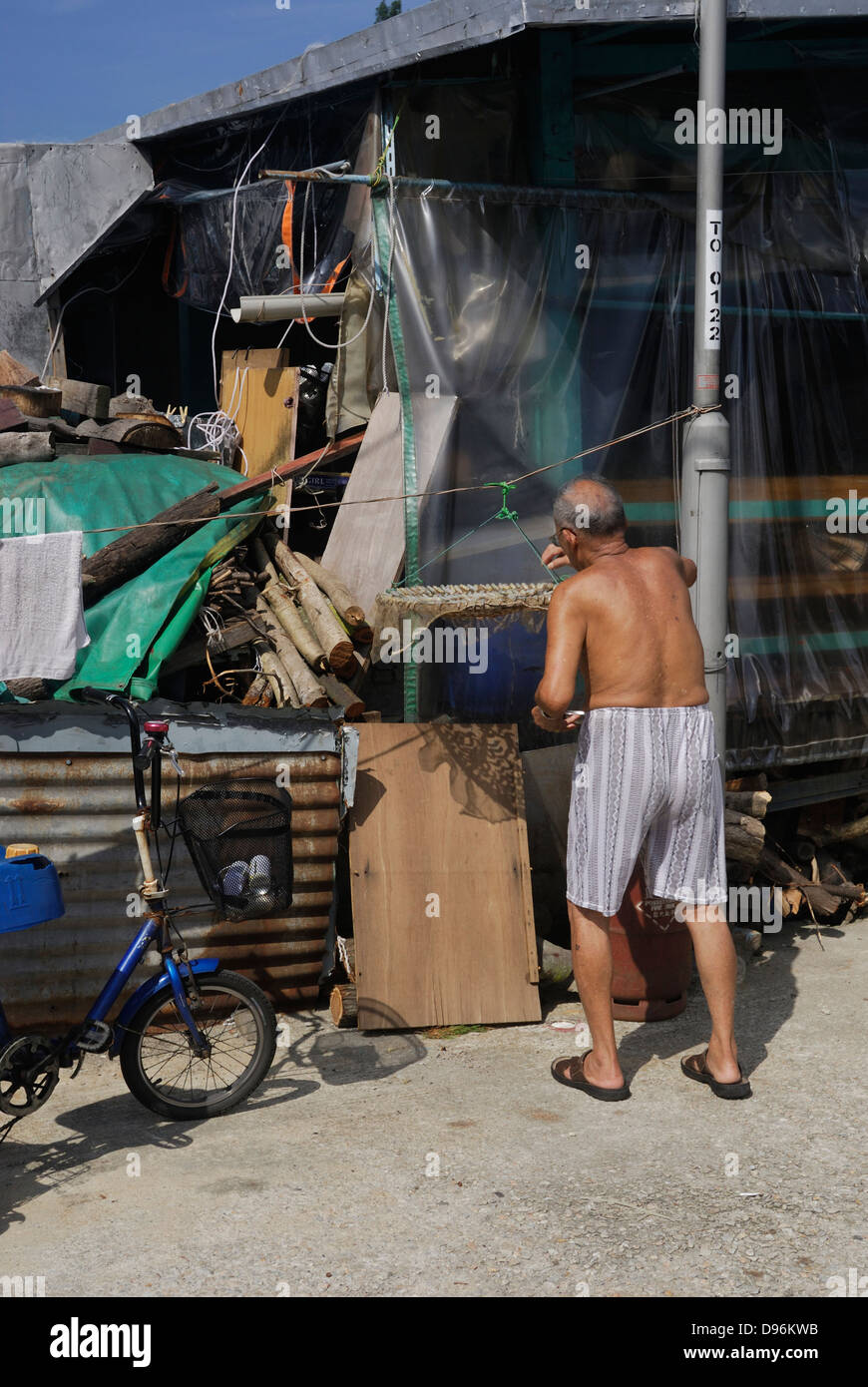 Local man drying fish outdoors, Tai O Lantau Island Hong Kong China ...