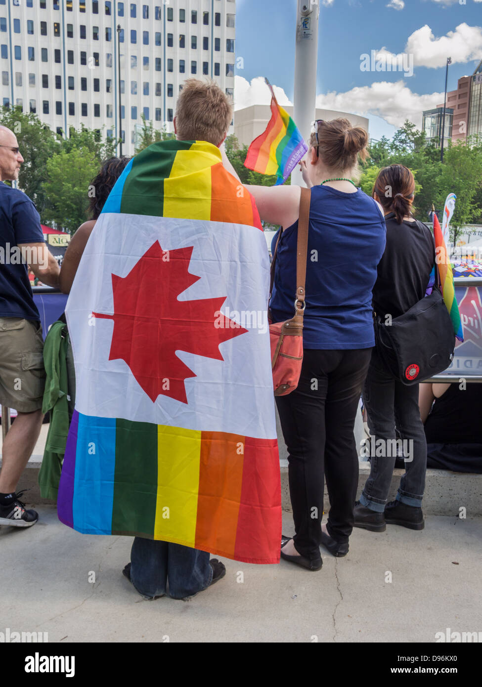 person wearing Canadian flag with pride colors at Edmonton Pride ...