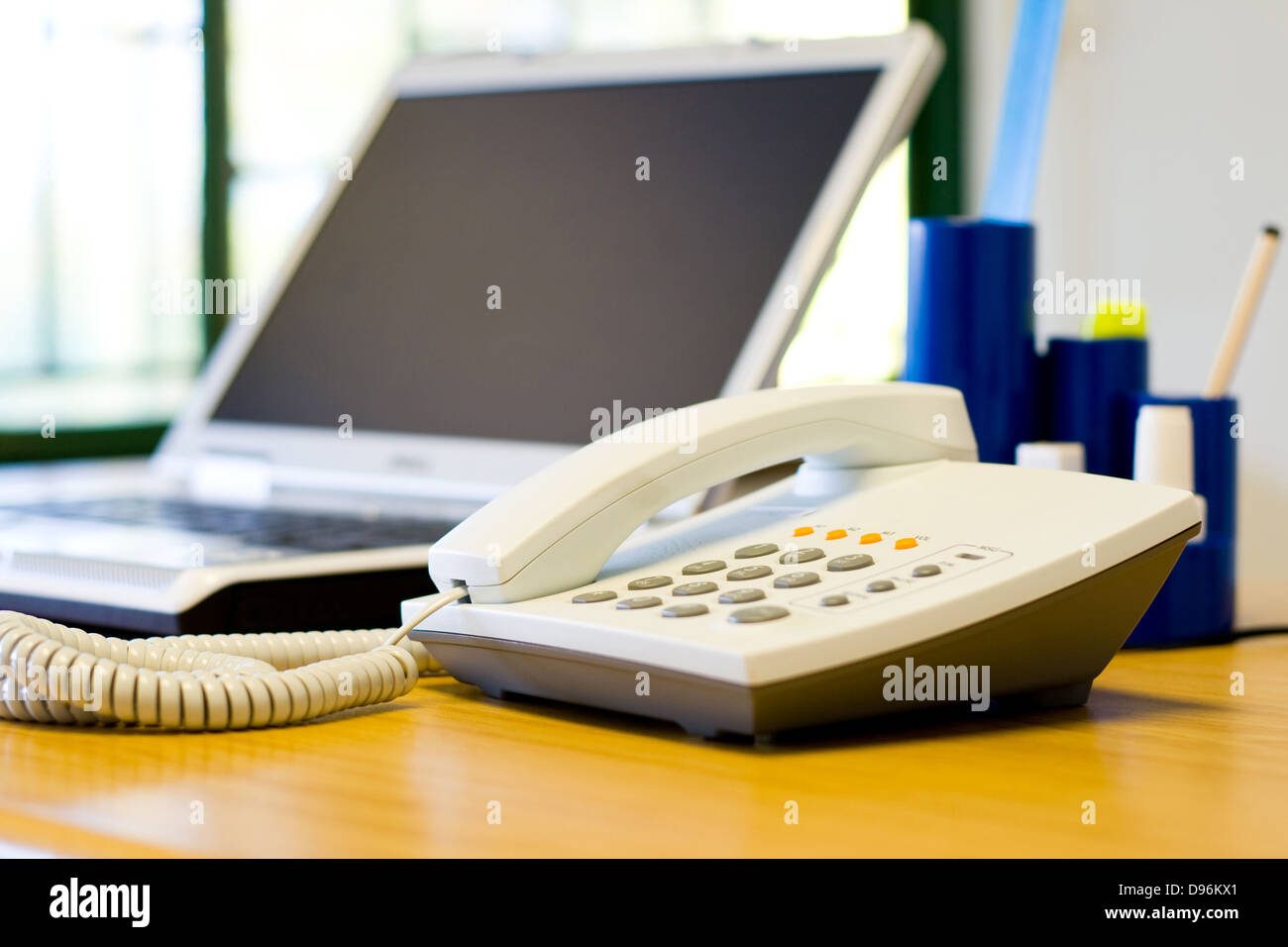 office desk with telephone and laptop Stock Photo - Alamy