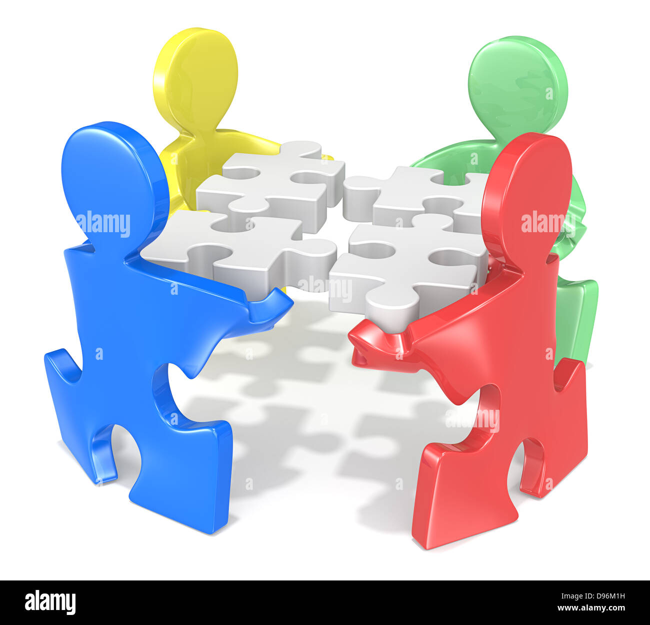 Puzzle People x 4 holding puzzle pieces Stock Photo - Alamy