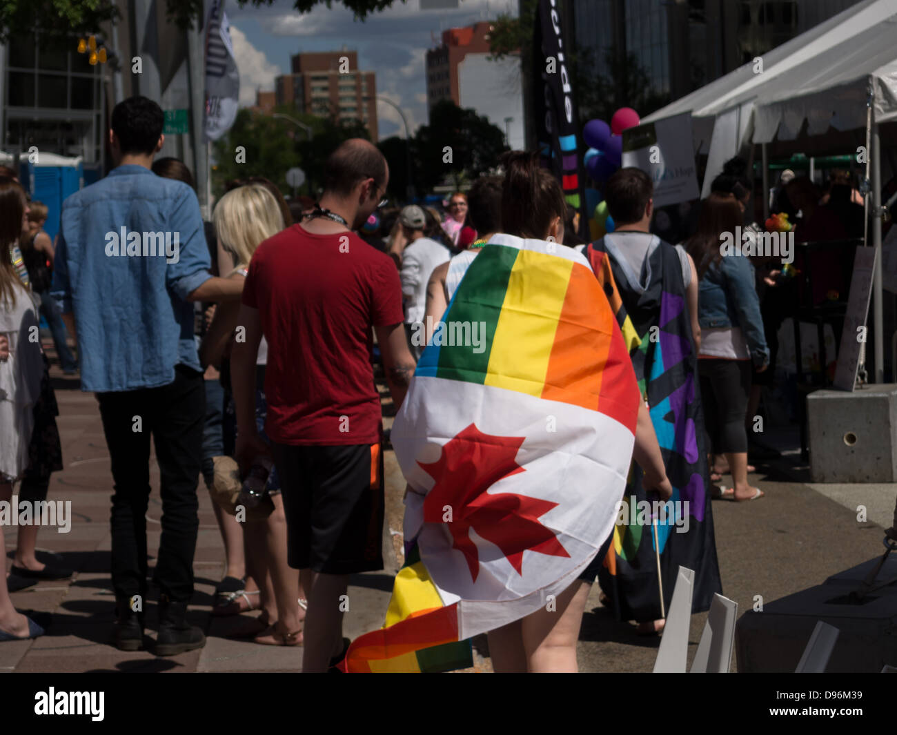 person wearing Canadian flag with pride colors at Edmonton Pride ...