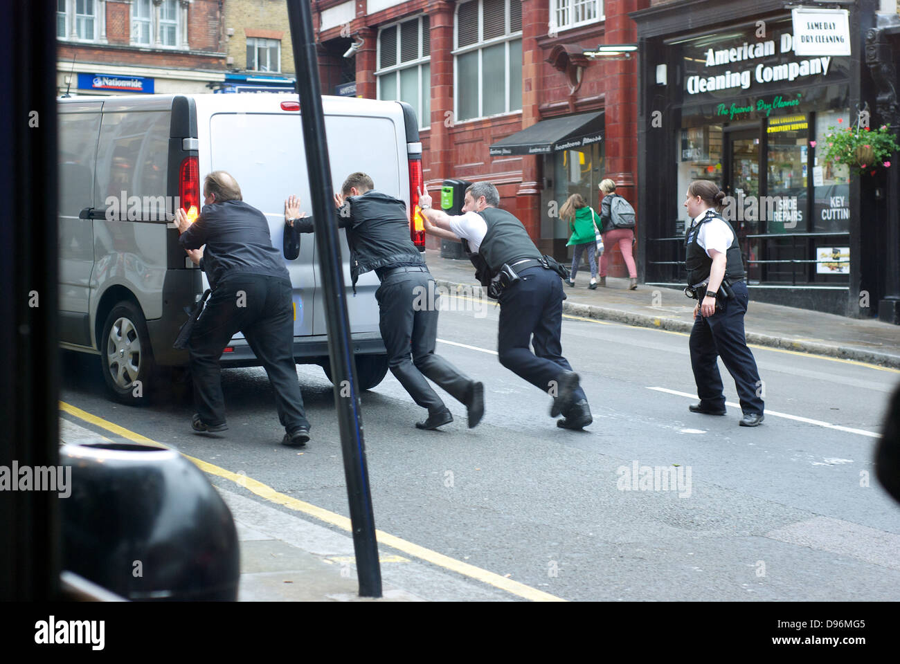 Police help broken down van driver as they push the van to a safe ...