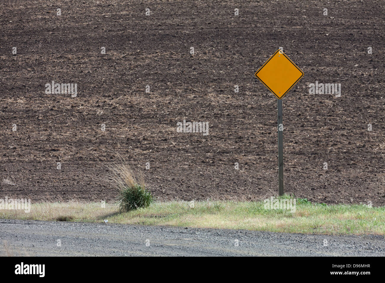 Yellow Road Sign and farm land Stock Photo - Alamy