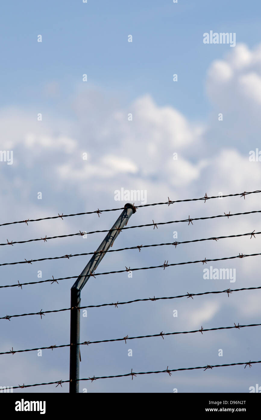 Clouds in the blue sky and barbed wire Stock Photo - Alamy