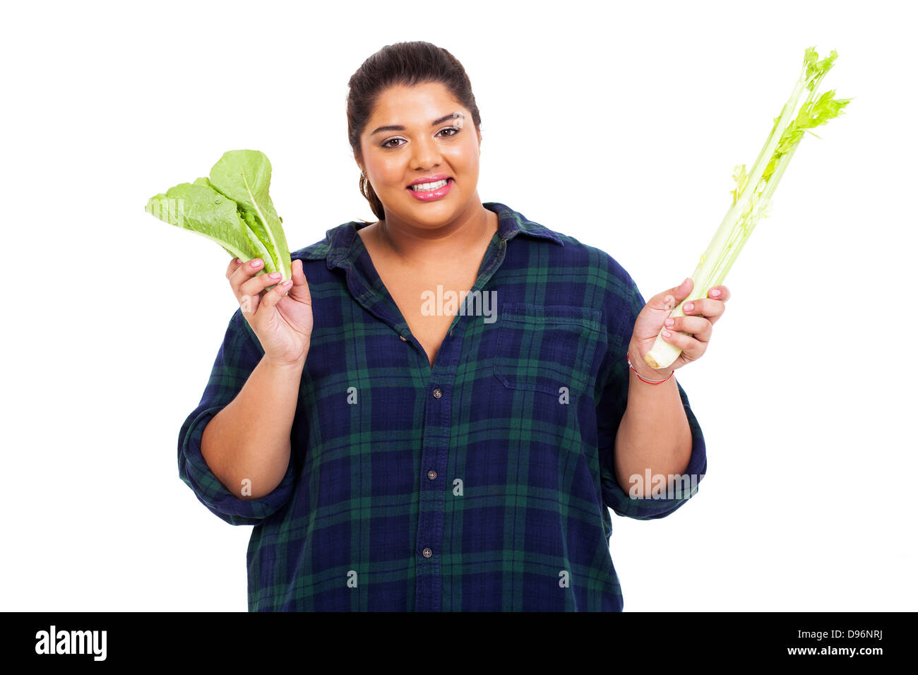 happy overweight woman holding green vegetables on white background ...