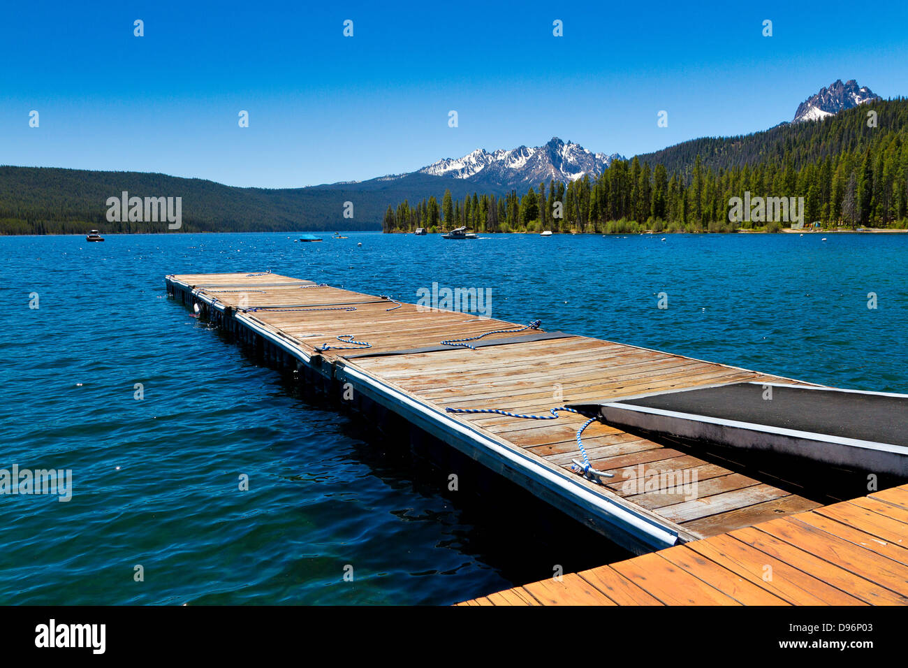 Wooden boat dock at north end of Redfish Lake with snowcapped mountains ...
