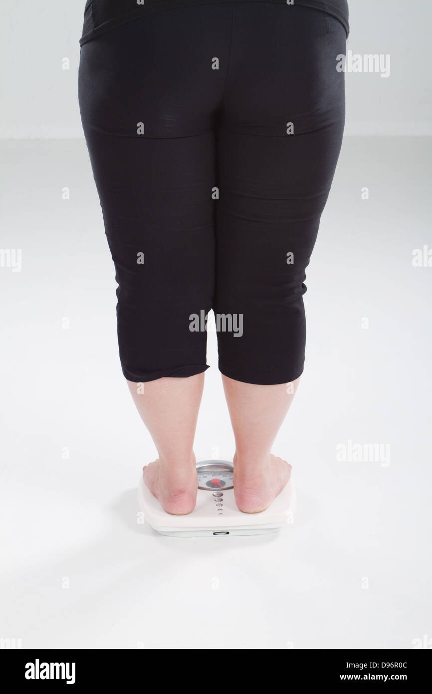overweight woman on scale weighting Stock Photo - Alamy