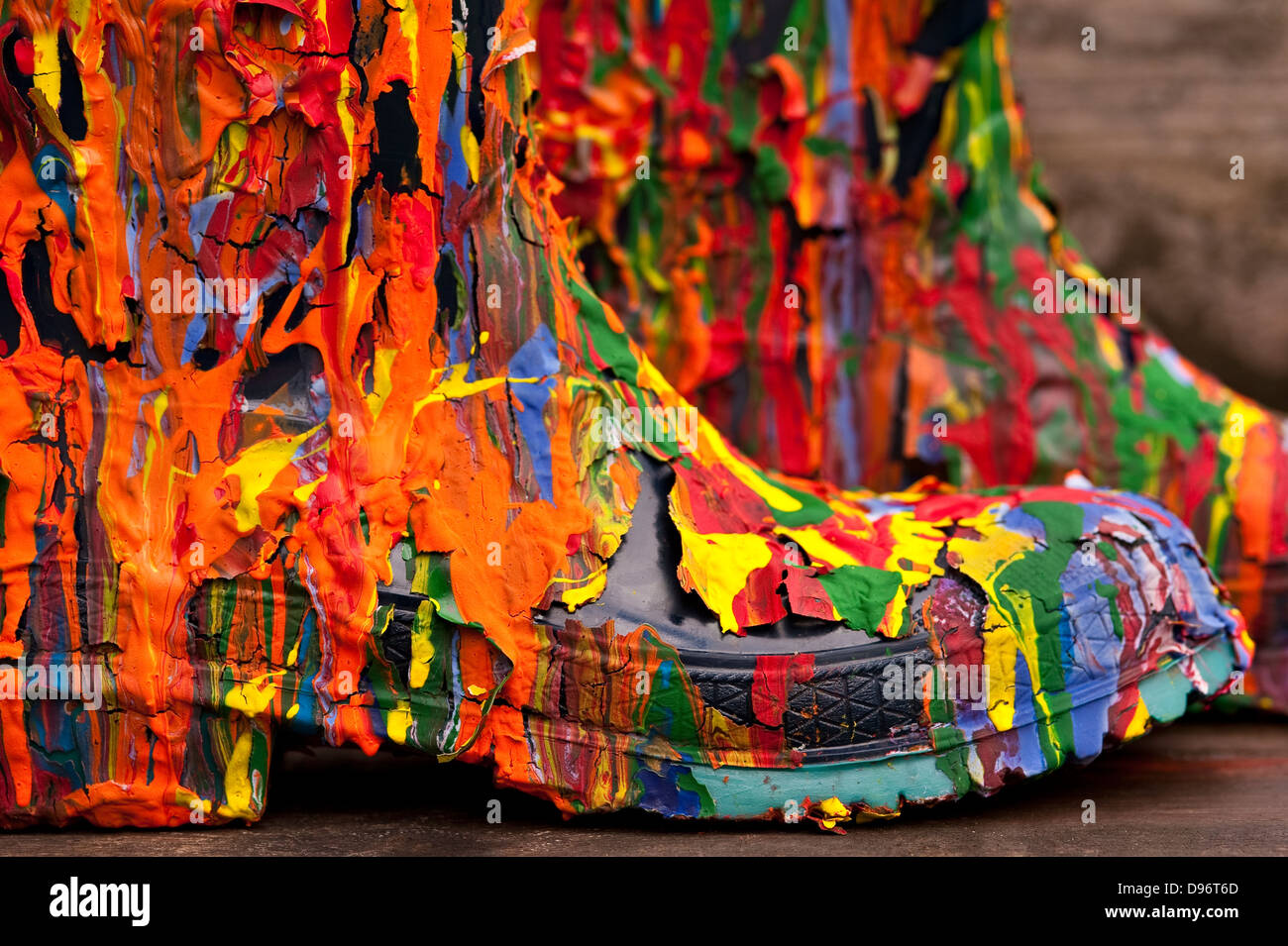 Boots covered with multicolored dripping peeling paint close up Stock ...