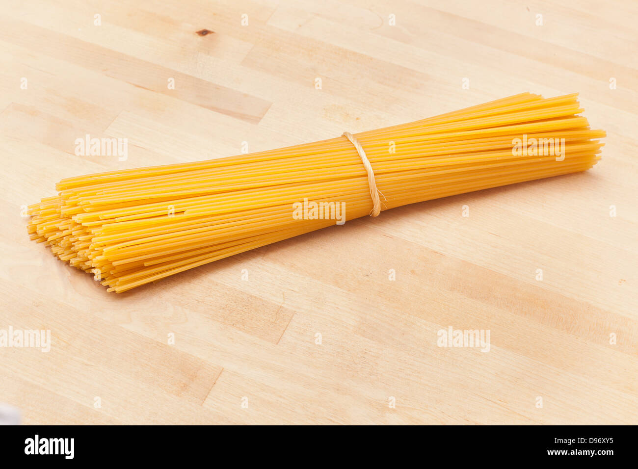 A Bundle of dry spaghetti ready to cook Stock Photo - Alamy