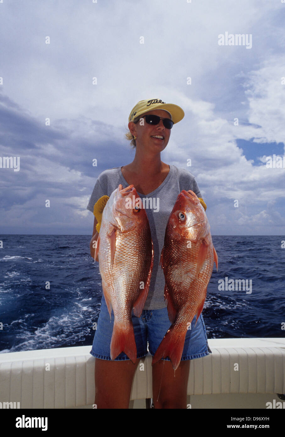 A woman with two red snapper (Lutjanus campechanus) caught near Port ...