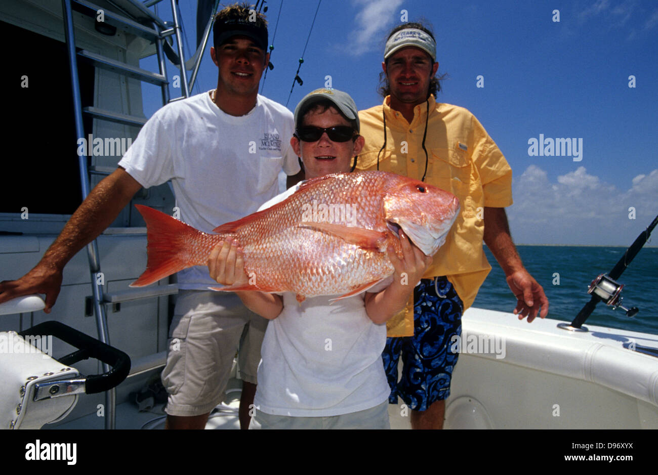 A young boy with a red snapper (Lutjanus campechanus) caught near Port ...