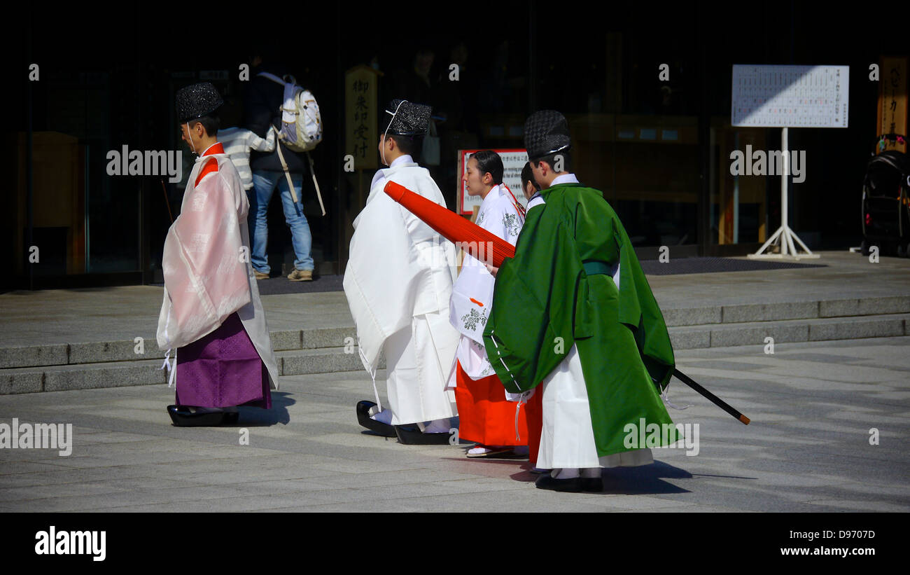 Kannushi and Miko walking back after performing religious rites for a ...