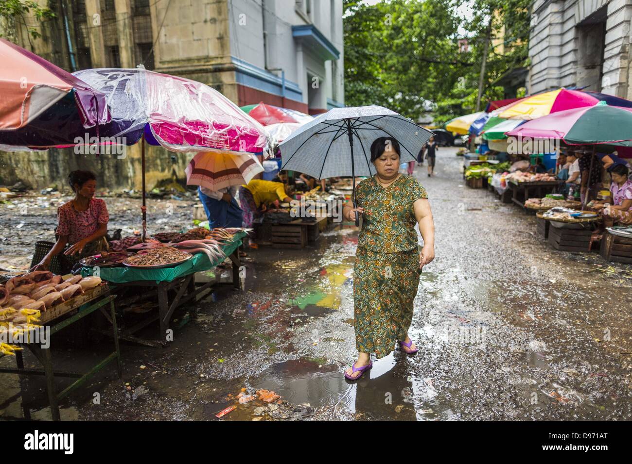 June 12, 2013 - Yangon, Union of Myanmar - Burmese woman walks through ...