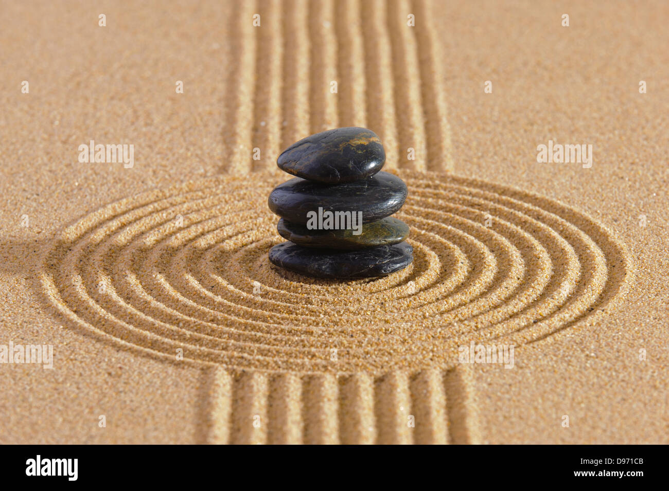 Japan garden with stacked stones in raked sand Stock Photo - Alamy