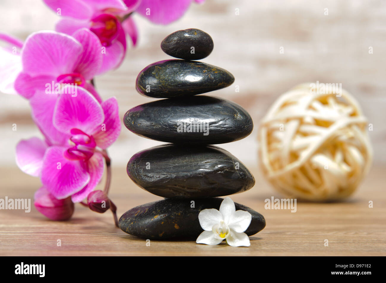 Japan zen garden with stacked stones and orchid flower Stock Photo - Alamy