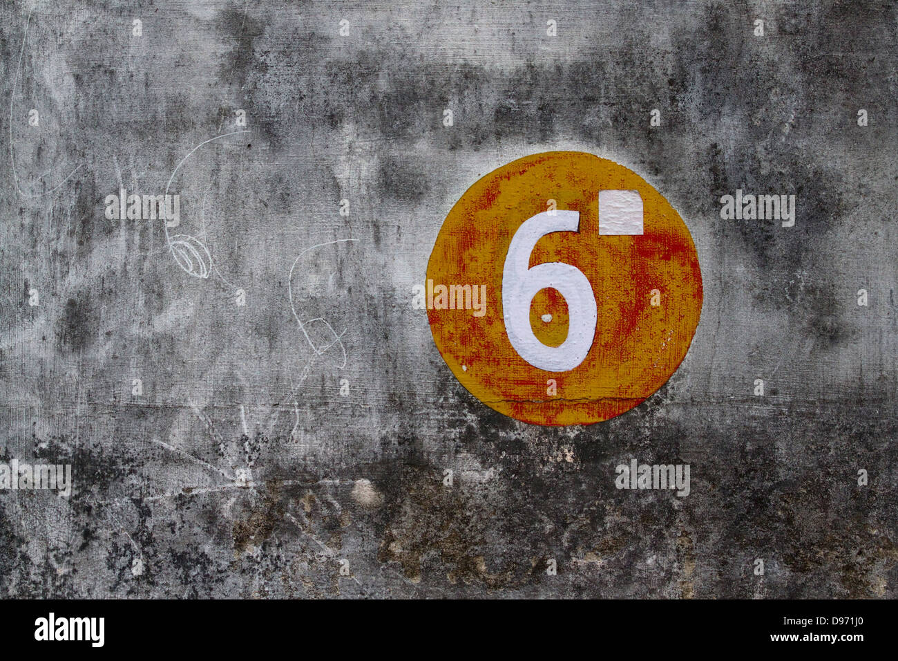 A hand painted number six on a wall, with some scratched graffiti Stock ...
