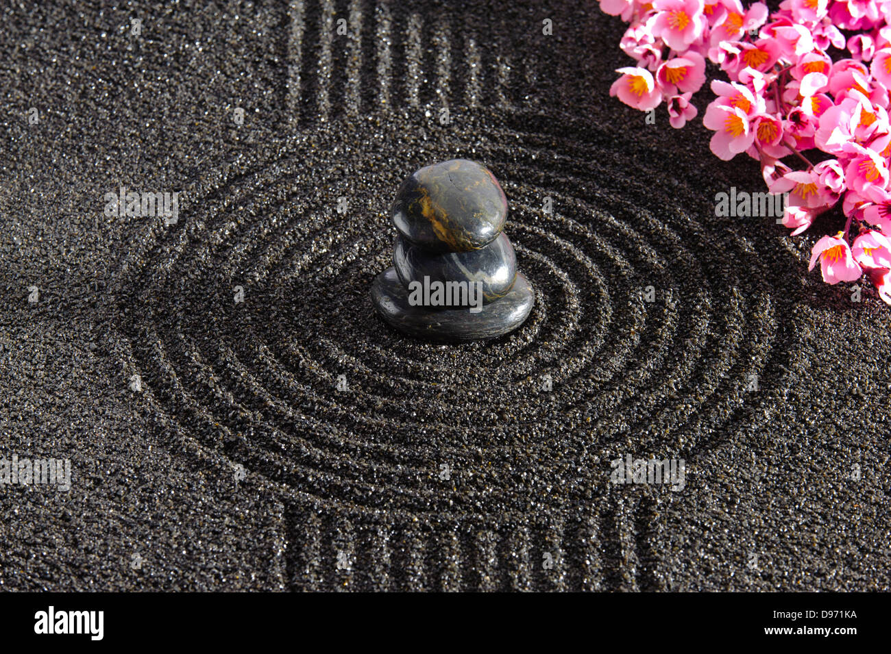 Japan garden with stacked stones in raked sand Stock Photo - Alamy